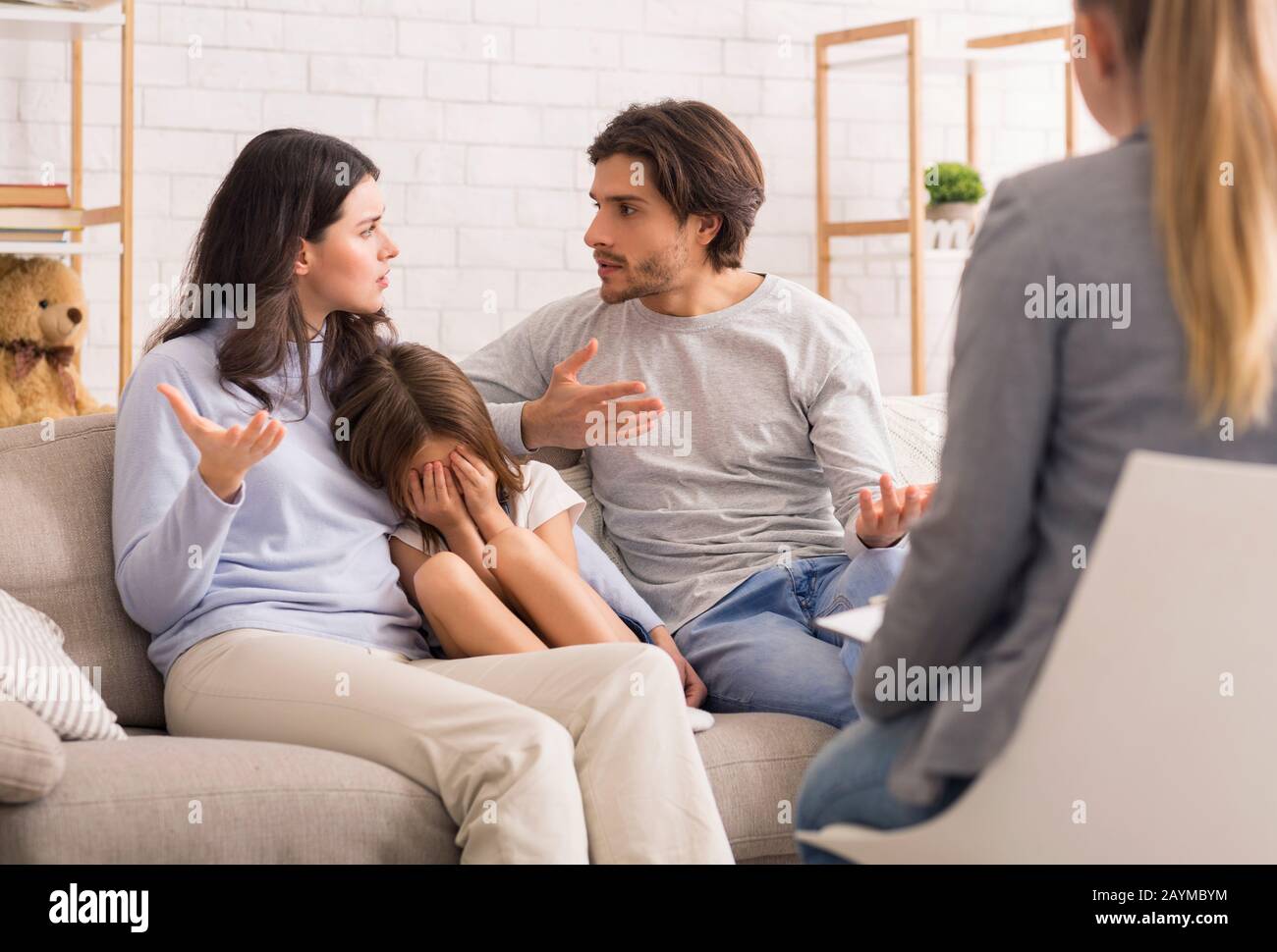 Little Girl Crying While Her Parents Argue At Counsellor's Office Stock ...