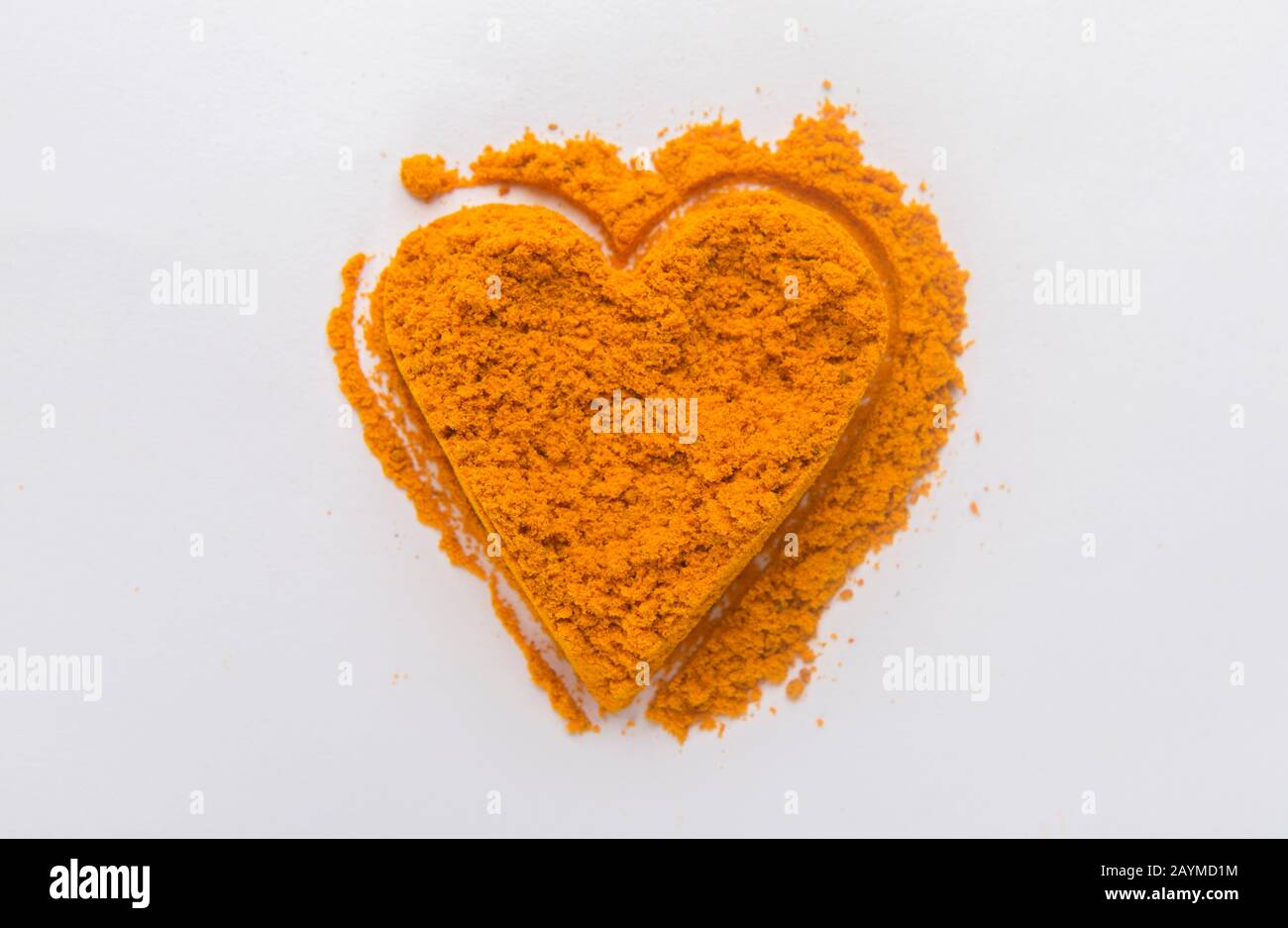 Heap ground turmeric isolated in heart shape on white Stock Photo - Alamy
