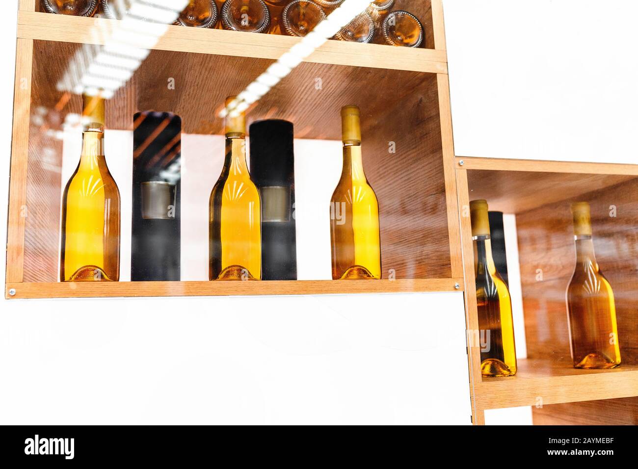 racks with bottles of yellow and white wine in shop Stock Photo - Alamy