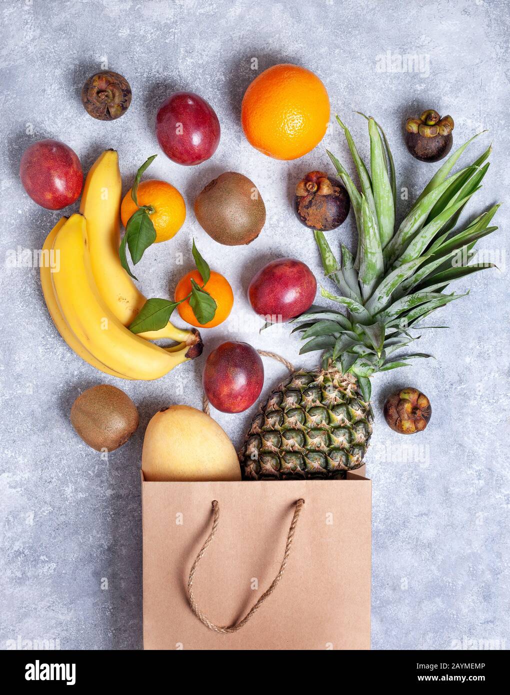 paper bag with tropical fruits: pineapple, mango, passion fruit on a ...