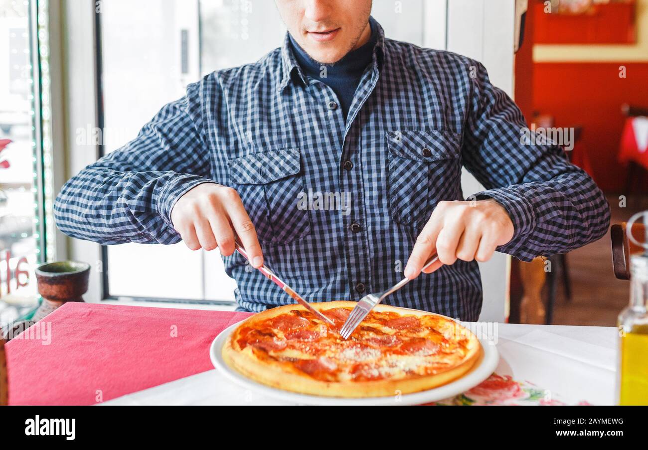 Man using fork knife eat hi-res stock photography and images - Alamy