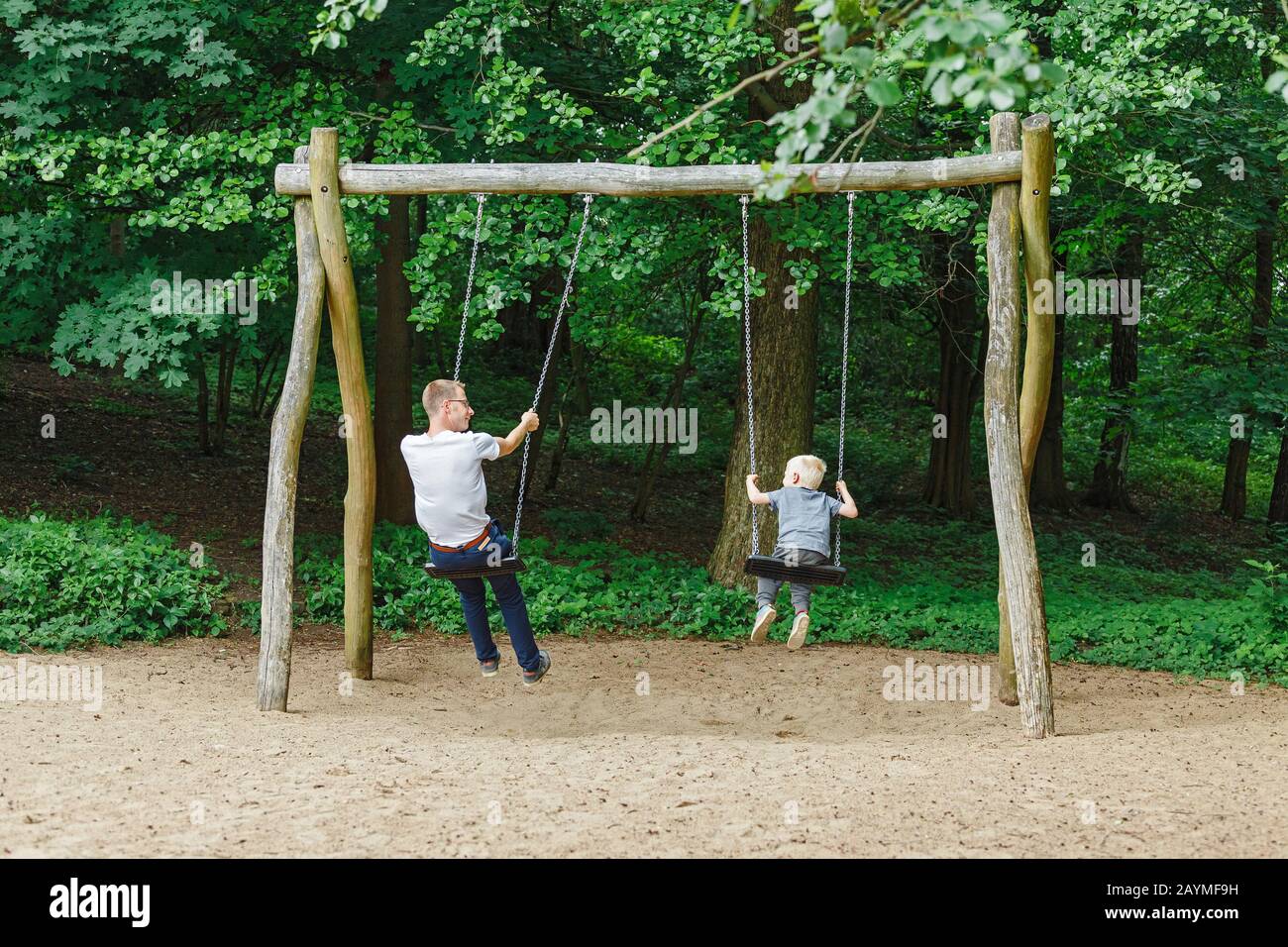 16 MAY 2018, BERLIN, GERMANY: Father And Son Having Fun On Swing In ...