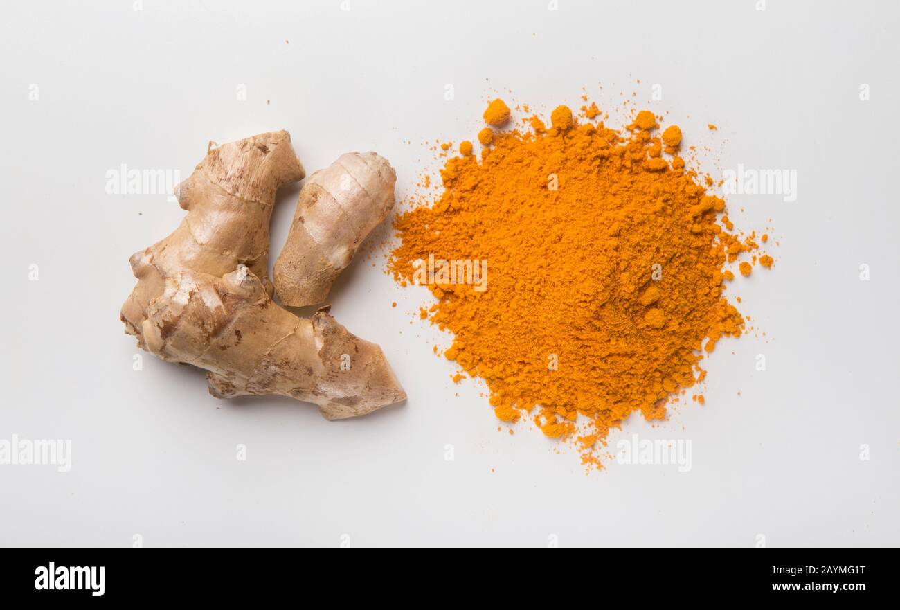 Turmeric powder and curcuma root on white background Stock Photo - Alamy