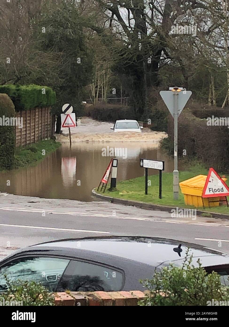 A car drives through a flooded road in the village of Findern in ...