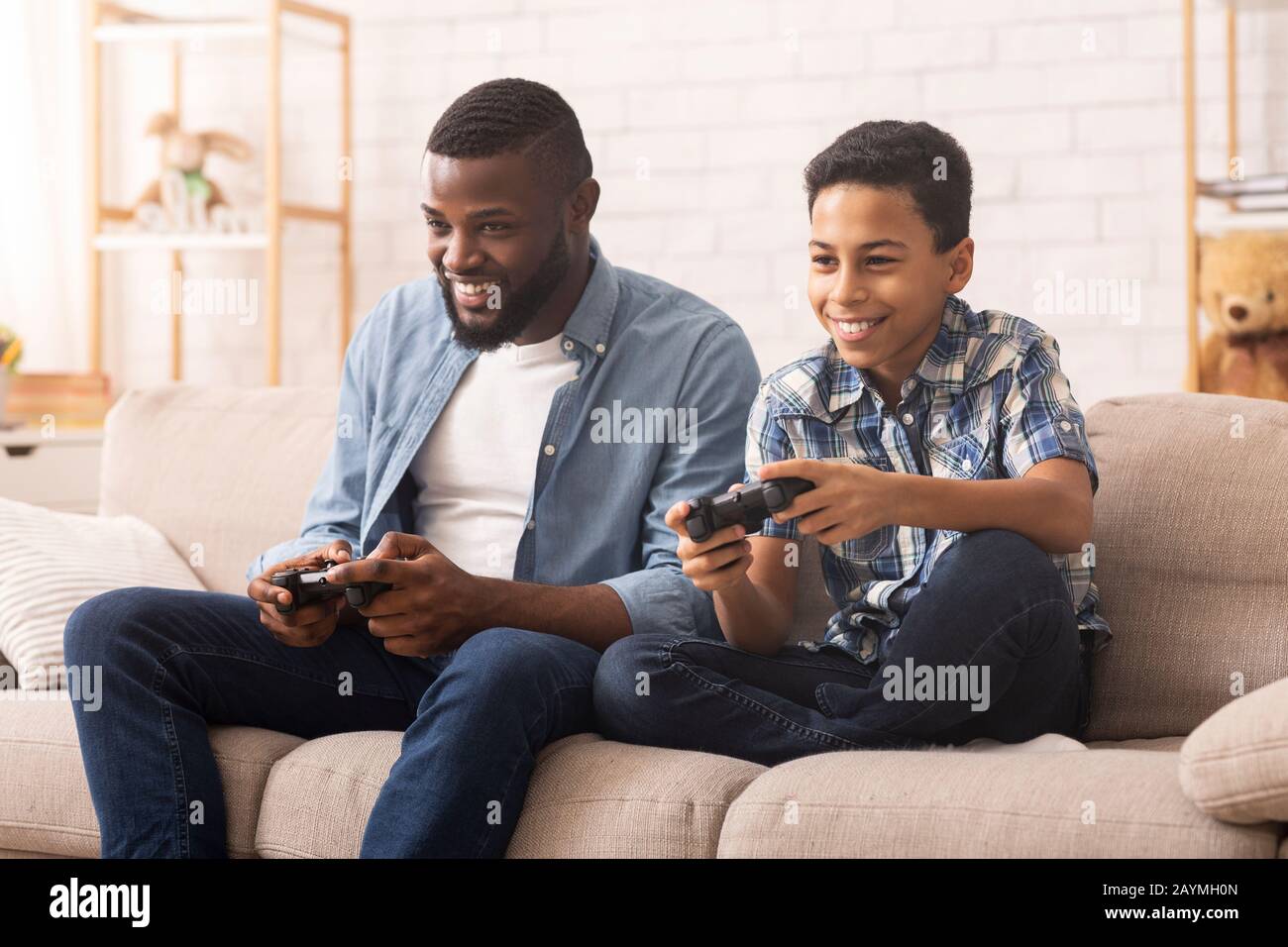 Excited Black Boy Playing Video Games With Dad At Home Stock Photo - Alamy