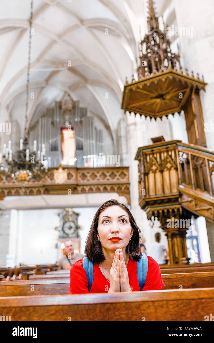 Woman praying in the church Stock Photo - Alamy