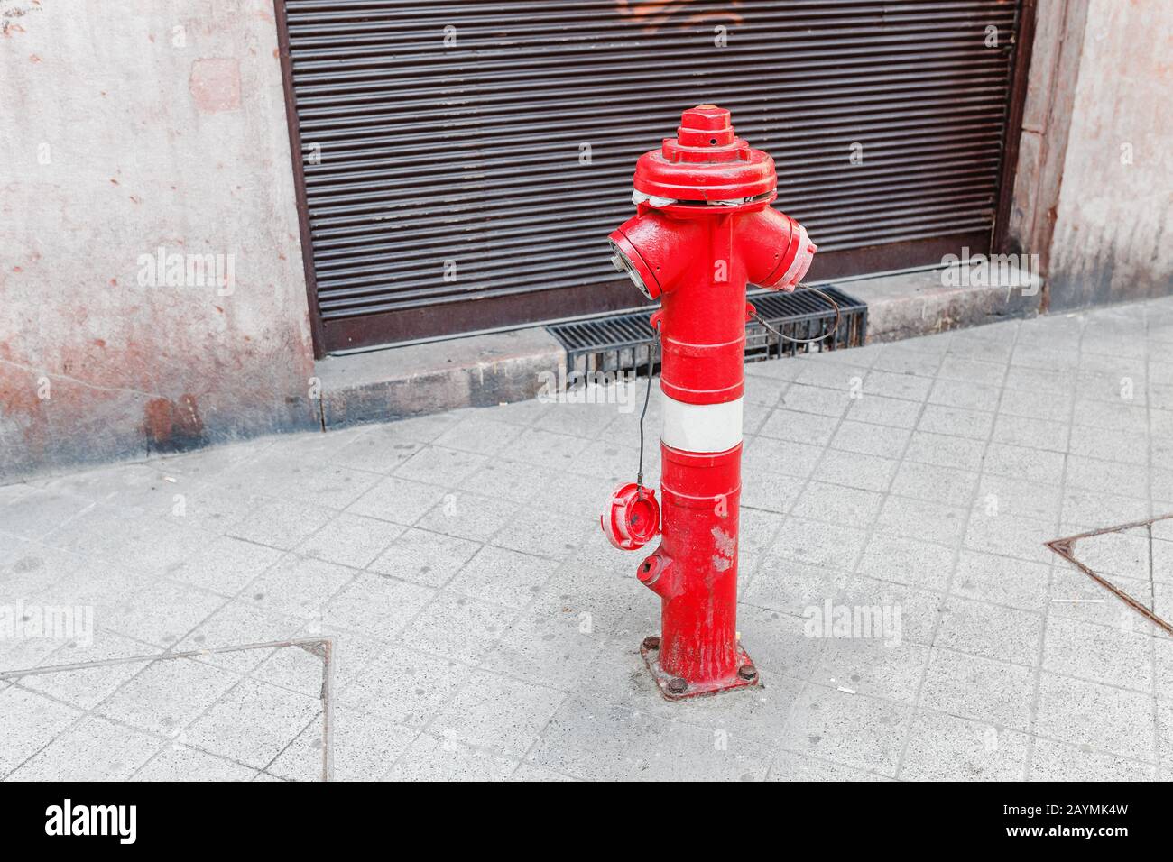 Red Fire Hydrant at narrow street of European city Stock Photo - Alamy