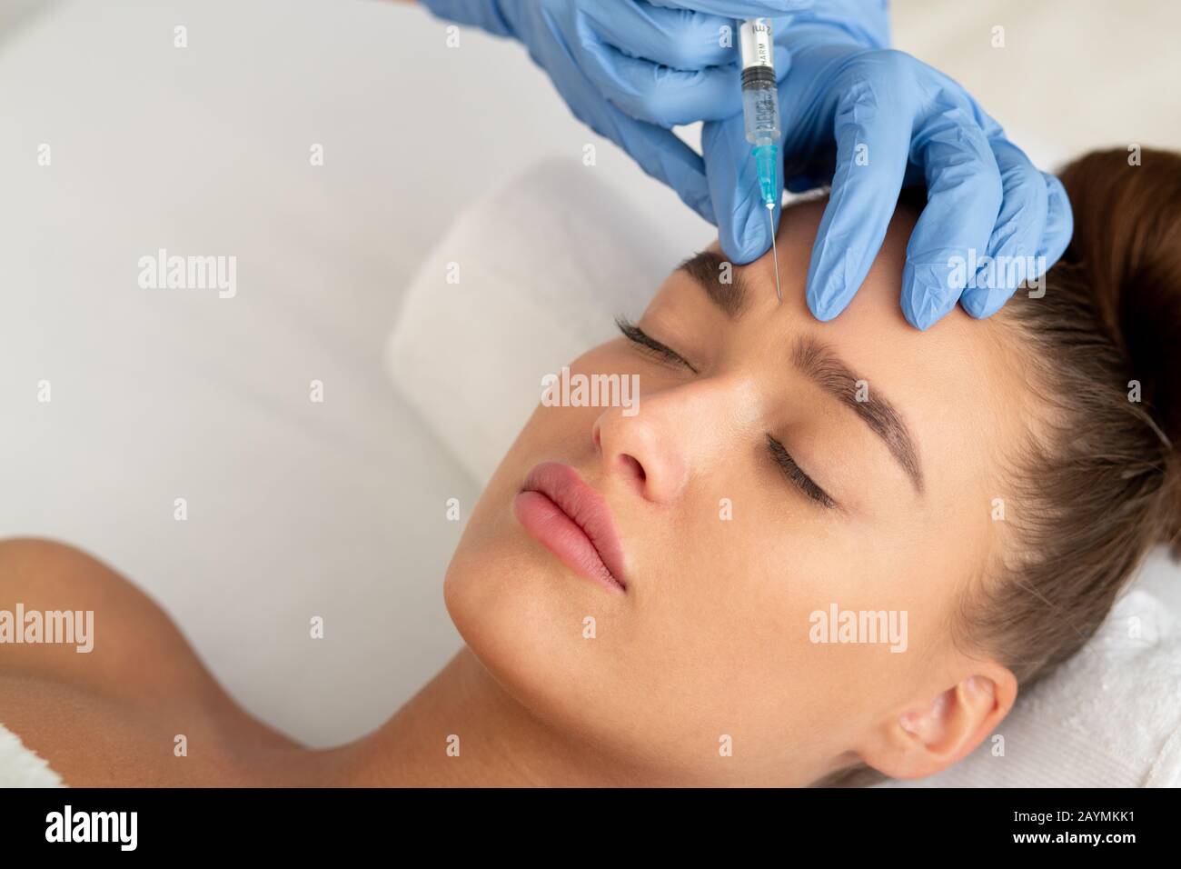 Beauty procedures. Woman receiving injection in forehead Stock Photo ...