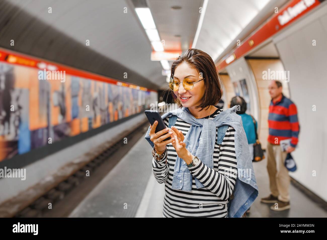 Woman using her smartphone application to know about public transport ...