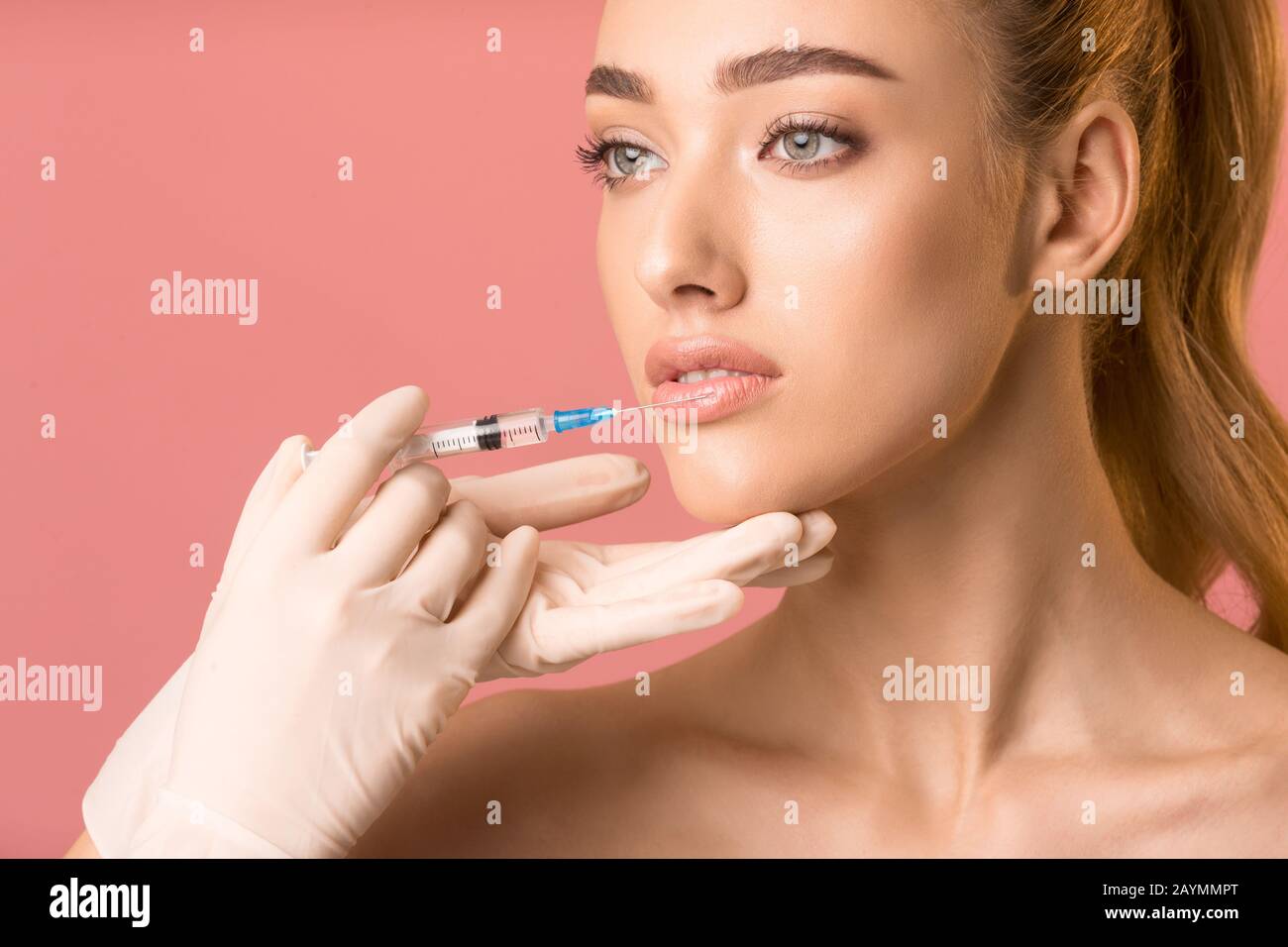 Pretty Girl Receiving Beauty Injection In Lips Over Pink Background ...