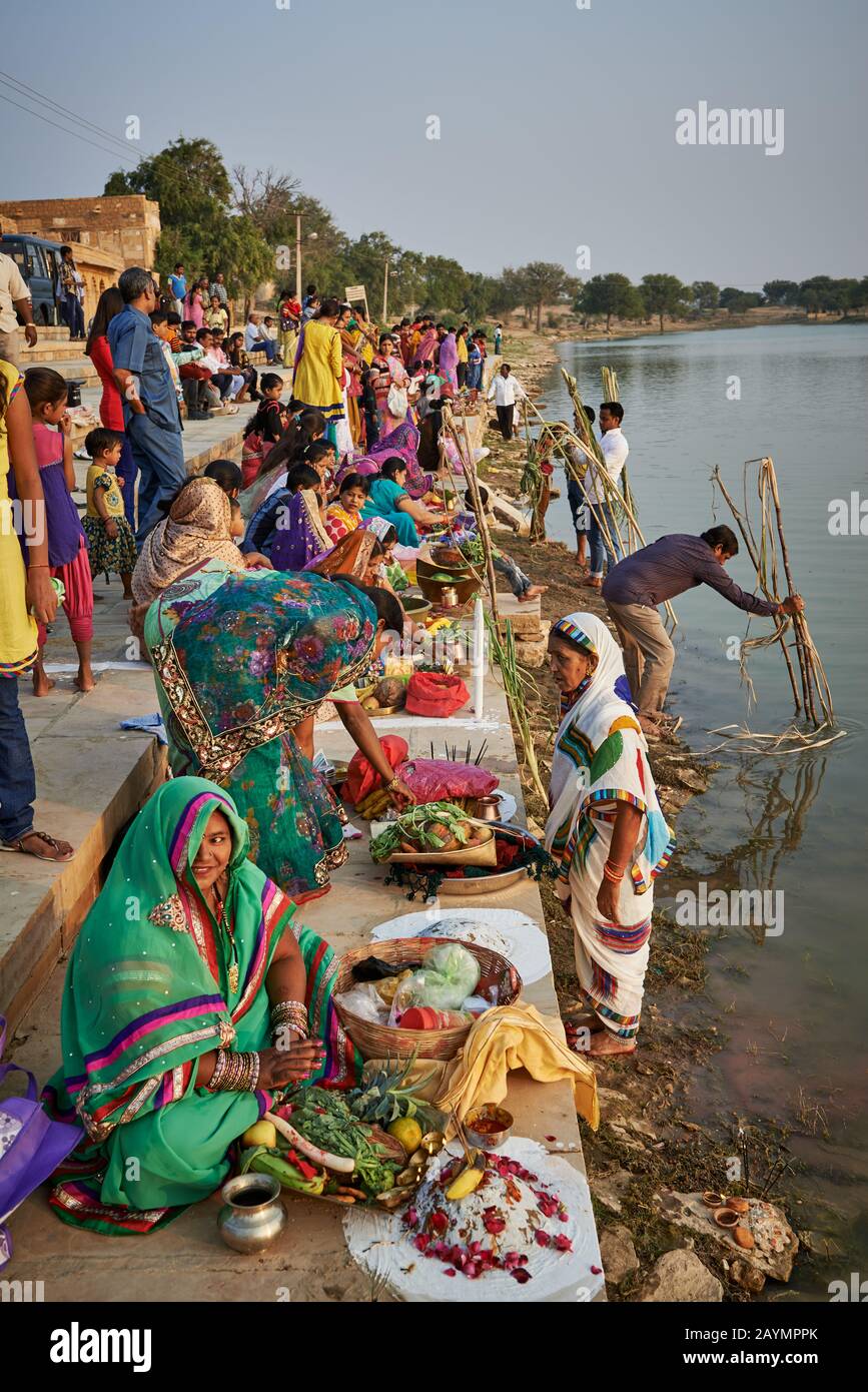 colorful dressed women celebrating ceremony at Ghat of Gadisar Lake ...