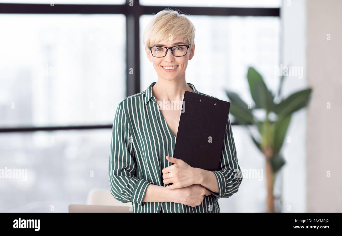 Successful Woman Holding Folder Smiling To Camera Standing In Office ...