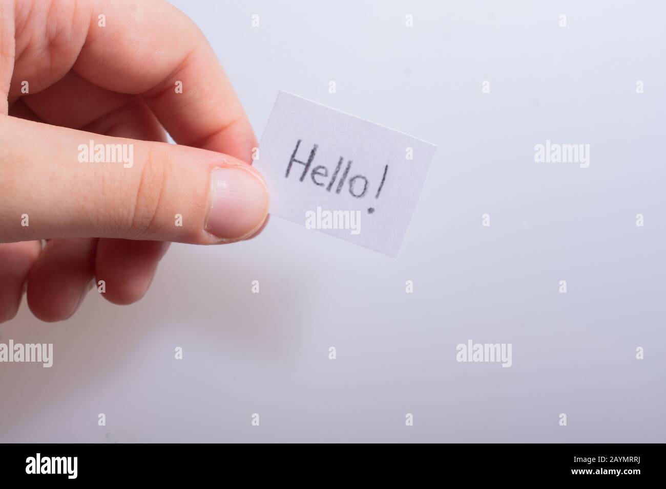 Hand holding notepaper with HELLO wording on white background Stock ...