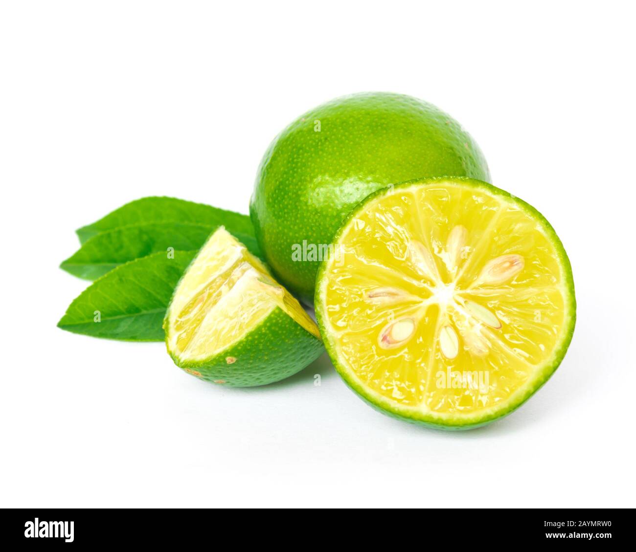 Pile of homegrown Asian limes with half cuts slices and green leaves ...