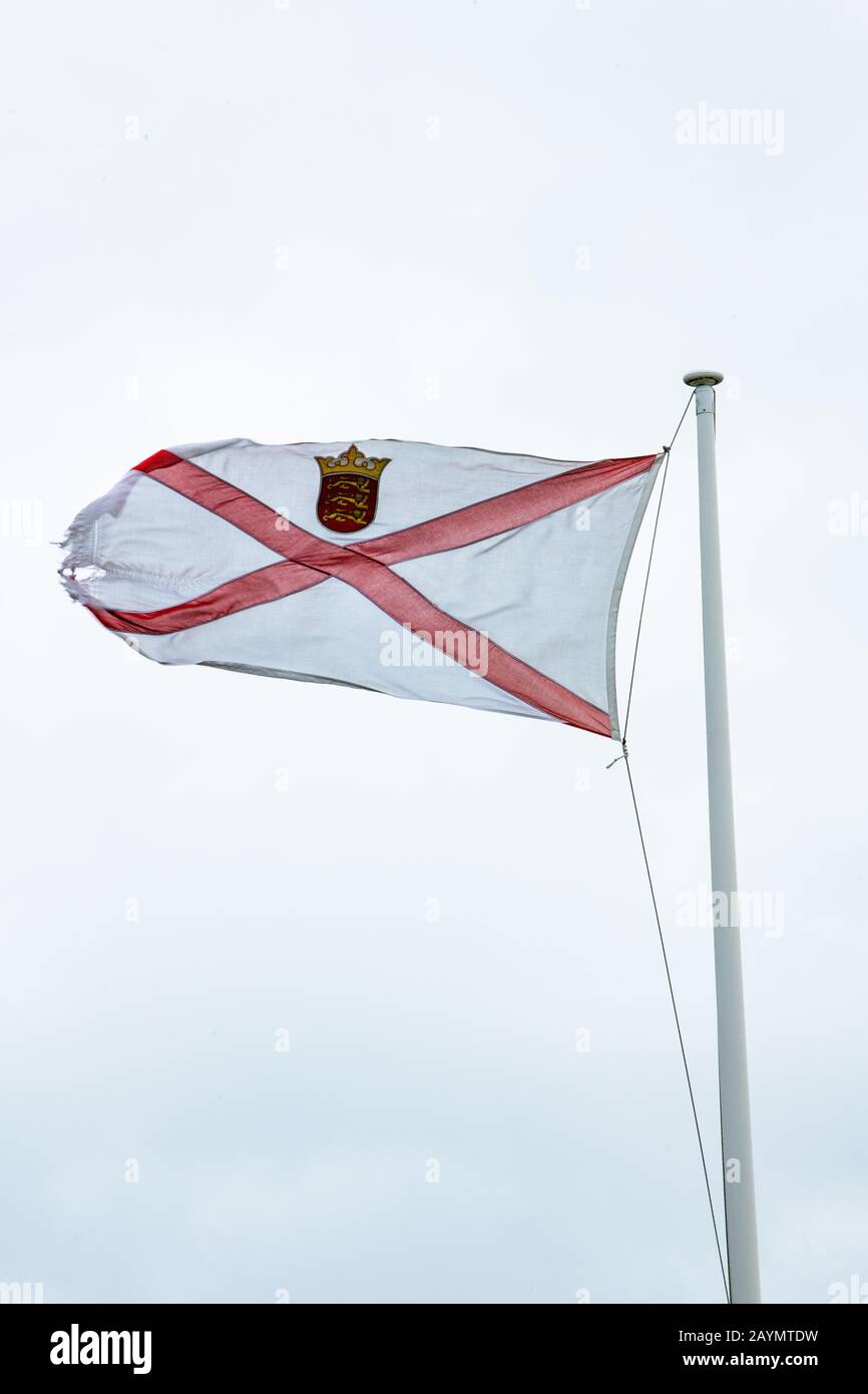 Jersey (Channel Islands) flag straining in the wind of Storm Dennis ...