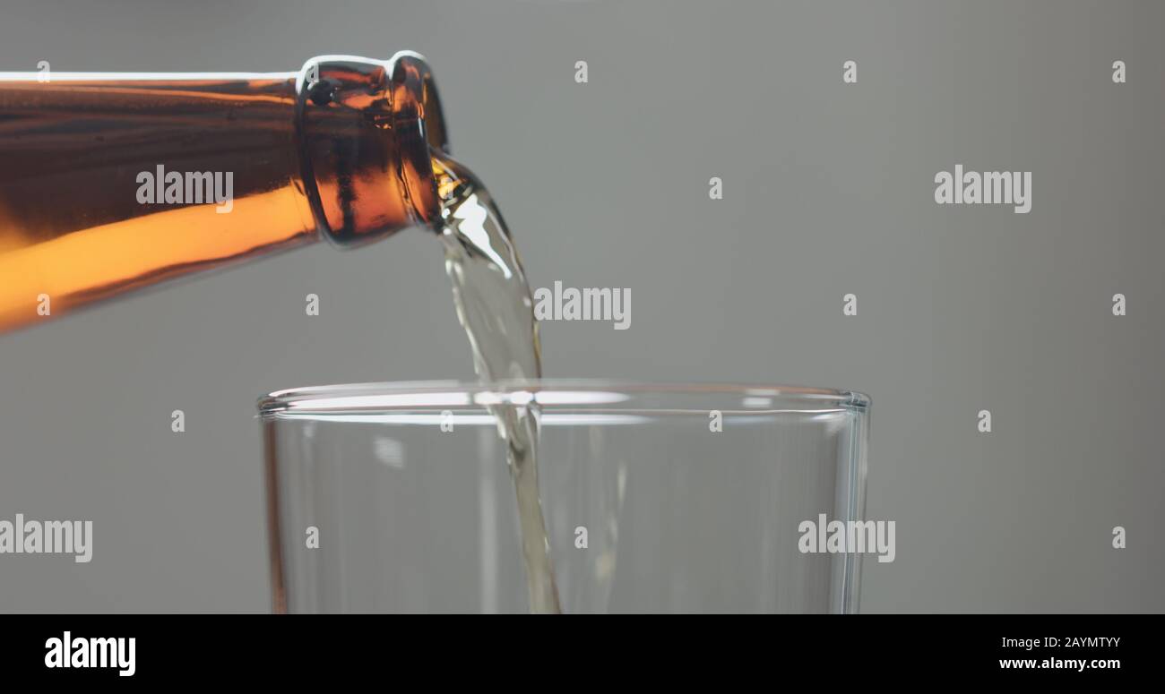 beer pour in glass from brown bottle, wide photo Stock Photo - Alamy