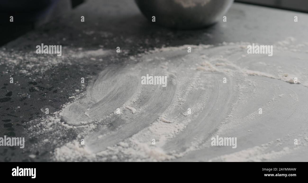 sprinkles flour on countertop surface, wide photo Stock Photo - Alamy