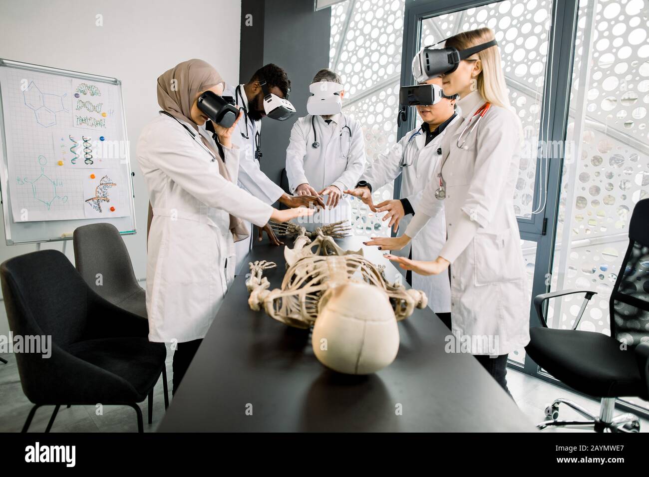 Young multiethnic doctors, bioengeneers, scientists with virtual ...