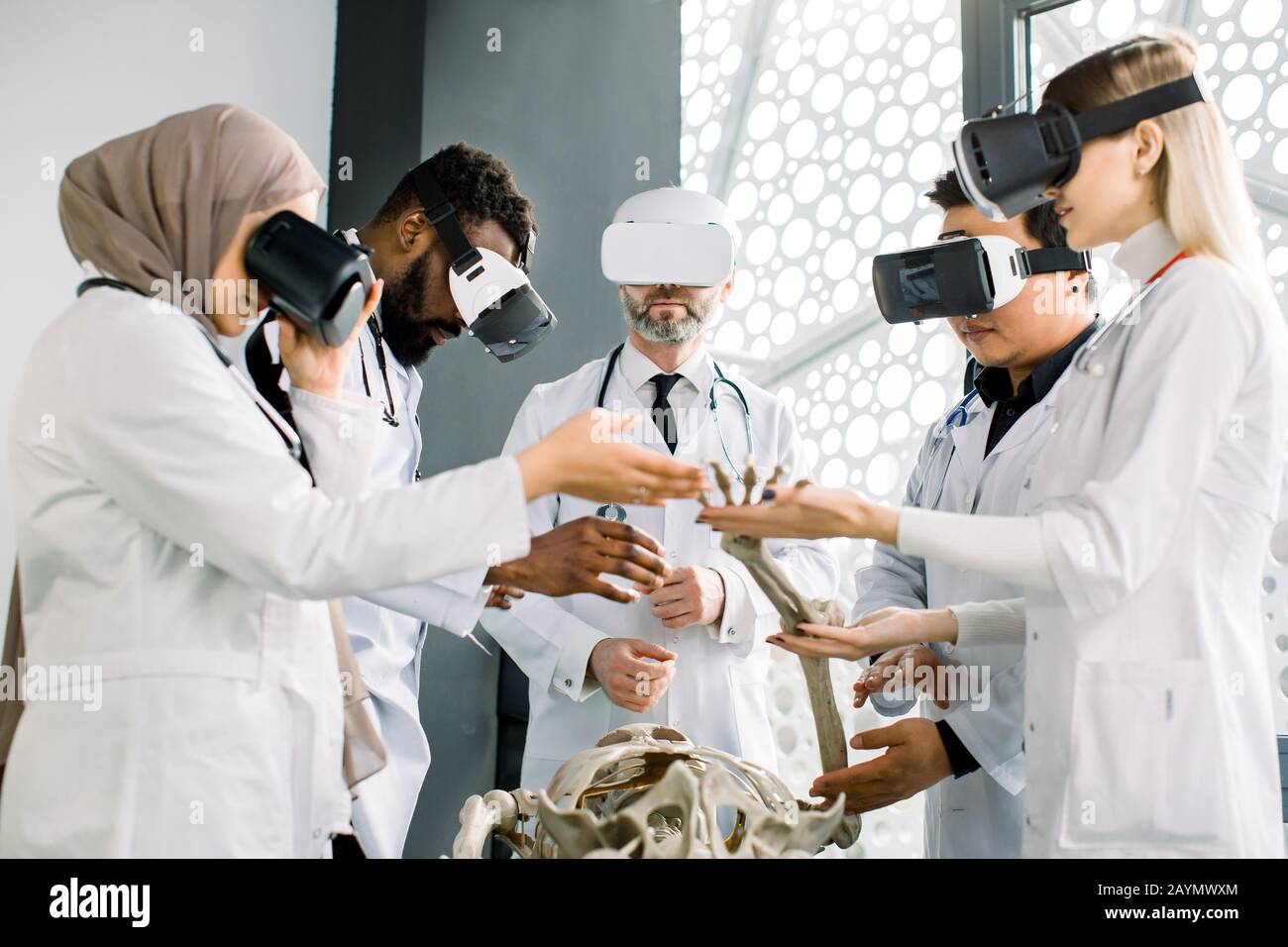 Group of multiethnic medical students or doctors and mature male ...