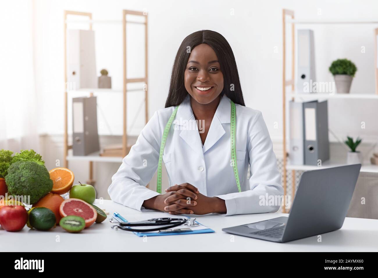 Smiling doctor nutritionist with vegetable and fruit in office Stock ...