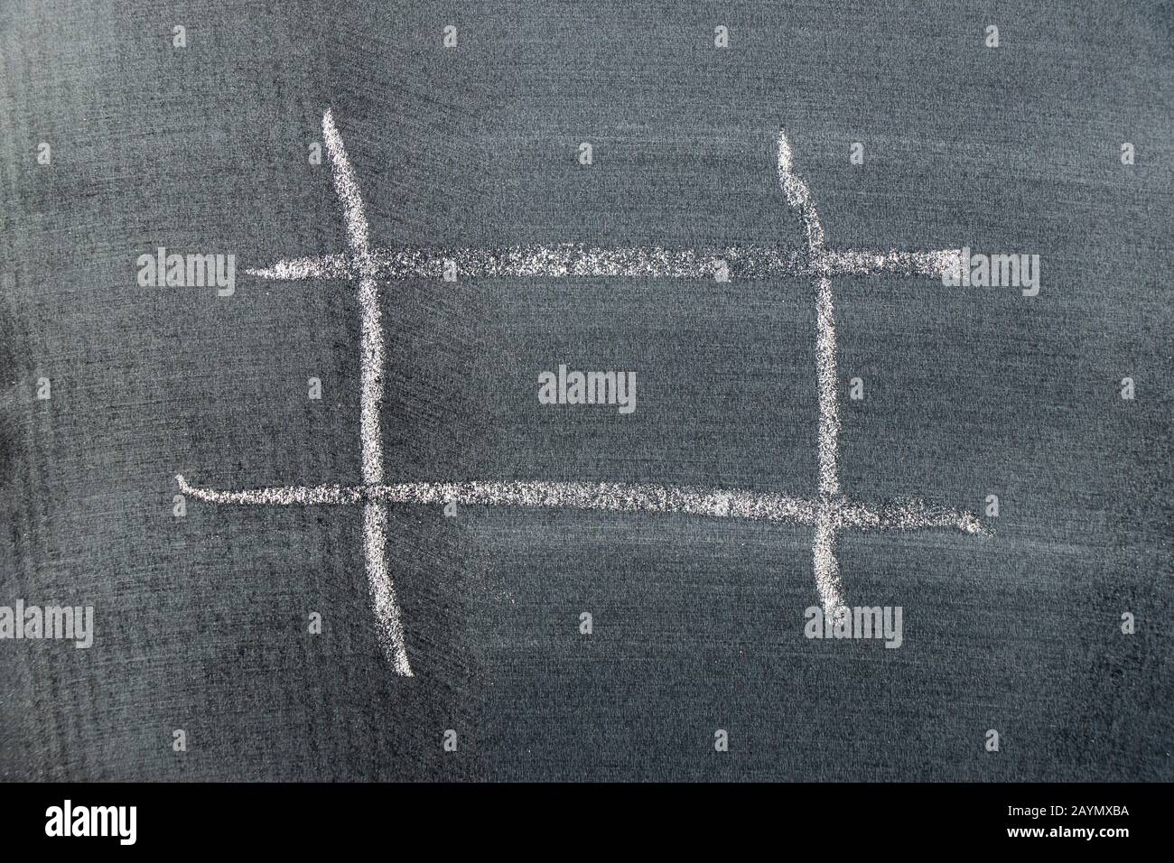 White color chalk hand drawing in square shape on black board ...