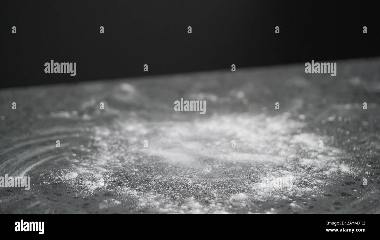 sprinkles flour on countertop surface, wide photo Stock Photo - Alamy