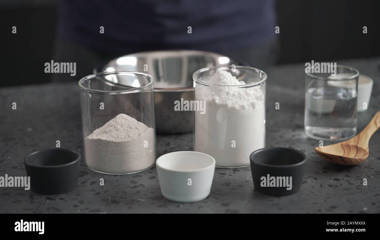 dry ingredients with flour in steel bowl on concrete countertop, wide ...