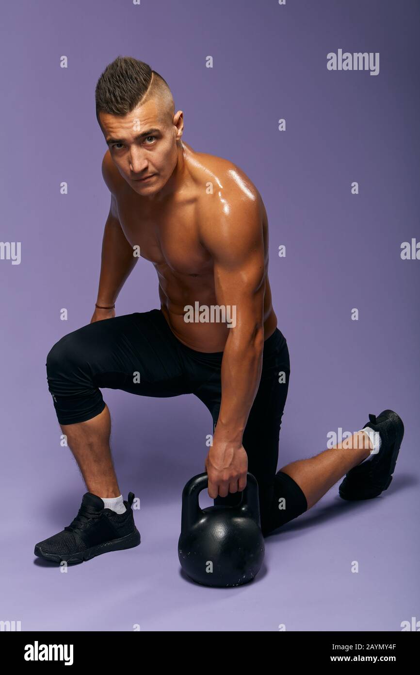 handsome tired guy having a rest after effective workout, looking at ...