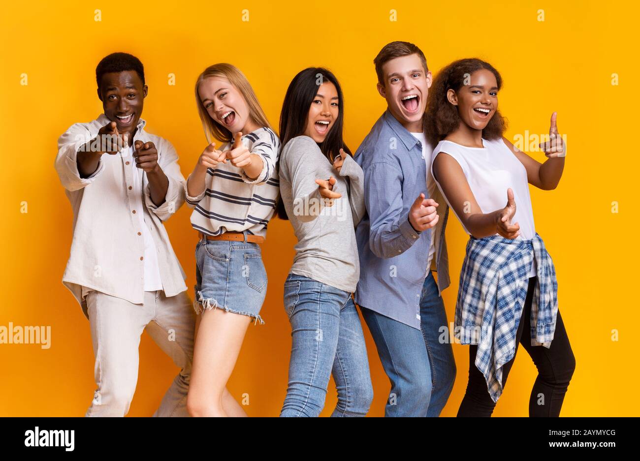 Cheerful multiracial group of students indicating at camera Stock Photo ...