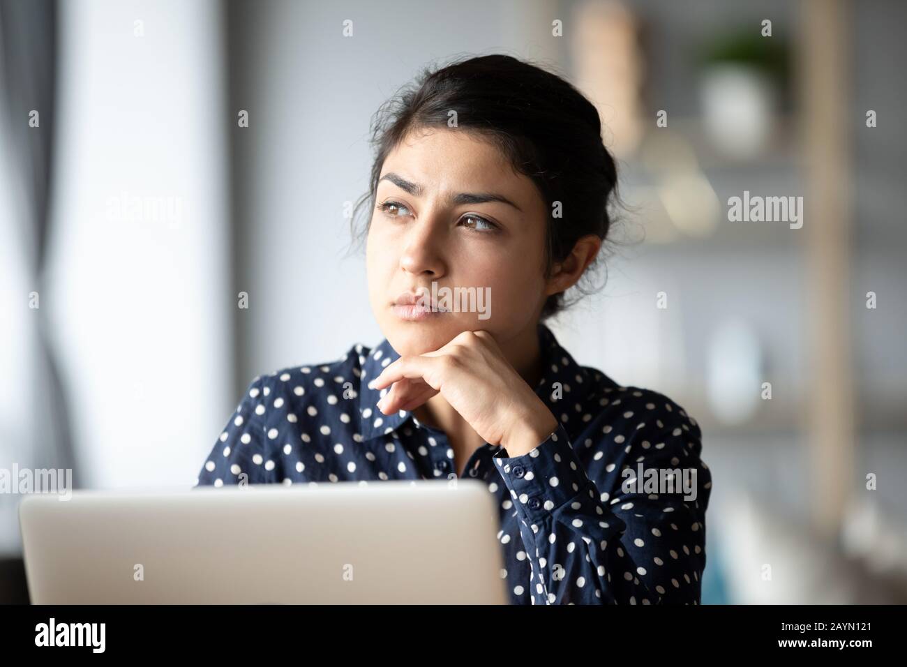 Pensive ethnic woman look in distance making decision Stock Photo - Alamy