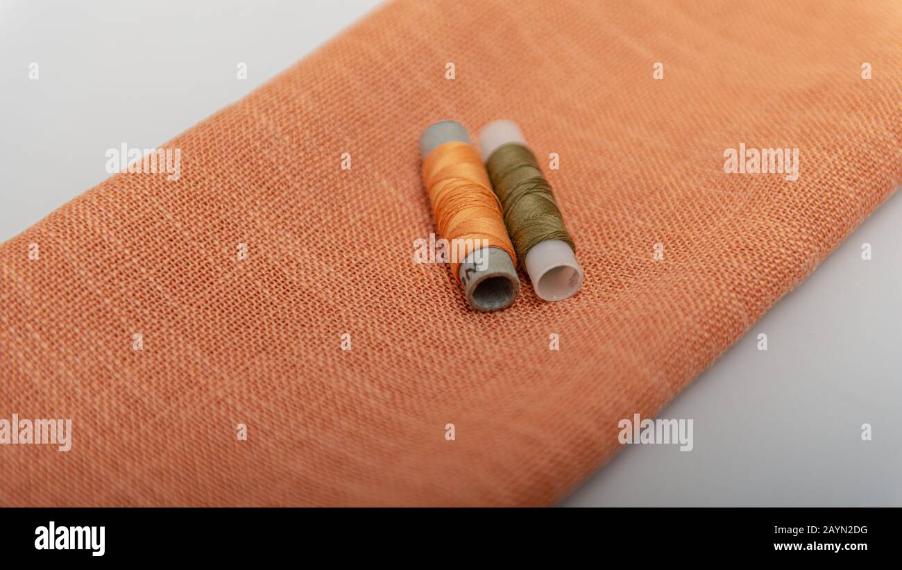 top view of color threads on the orange fabric Stock Photo - Alamy