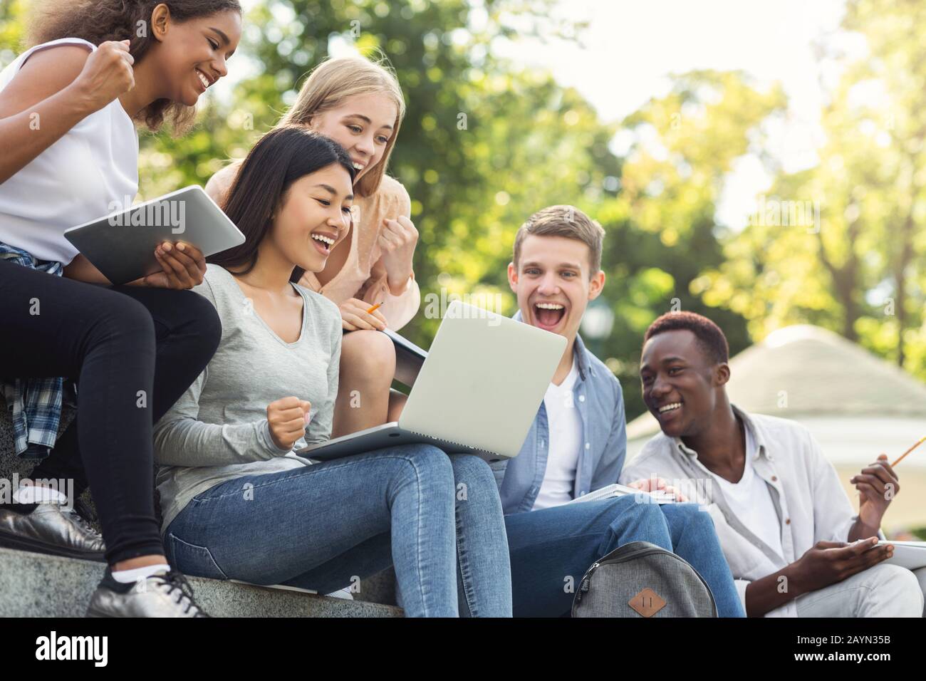 Group of international students celebrating success, checking exam ...