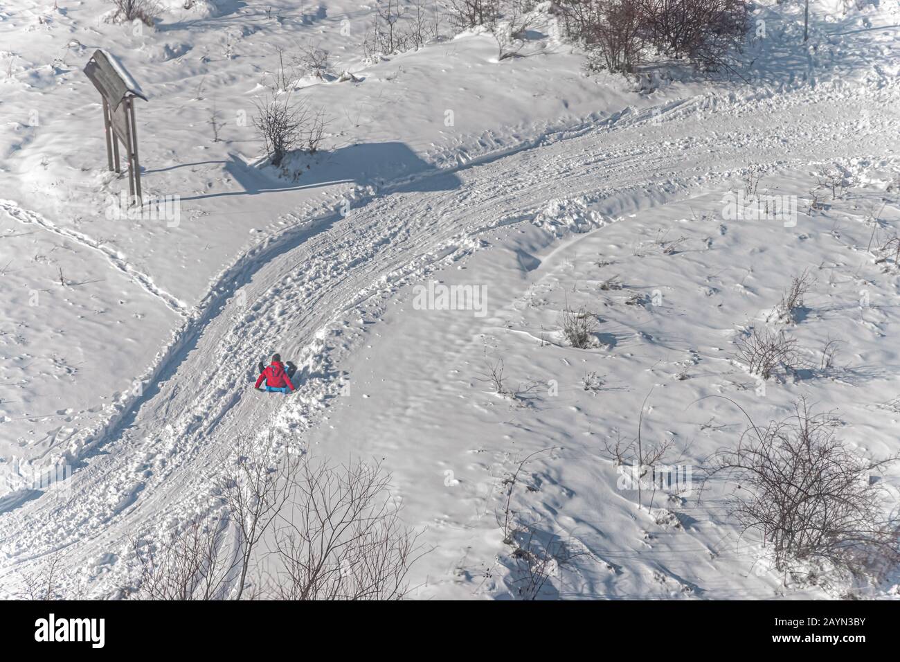 Kid snow sliding Stock Photo - Alamy