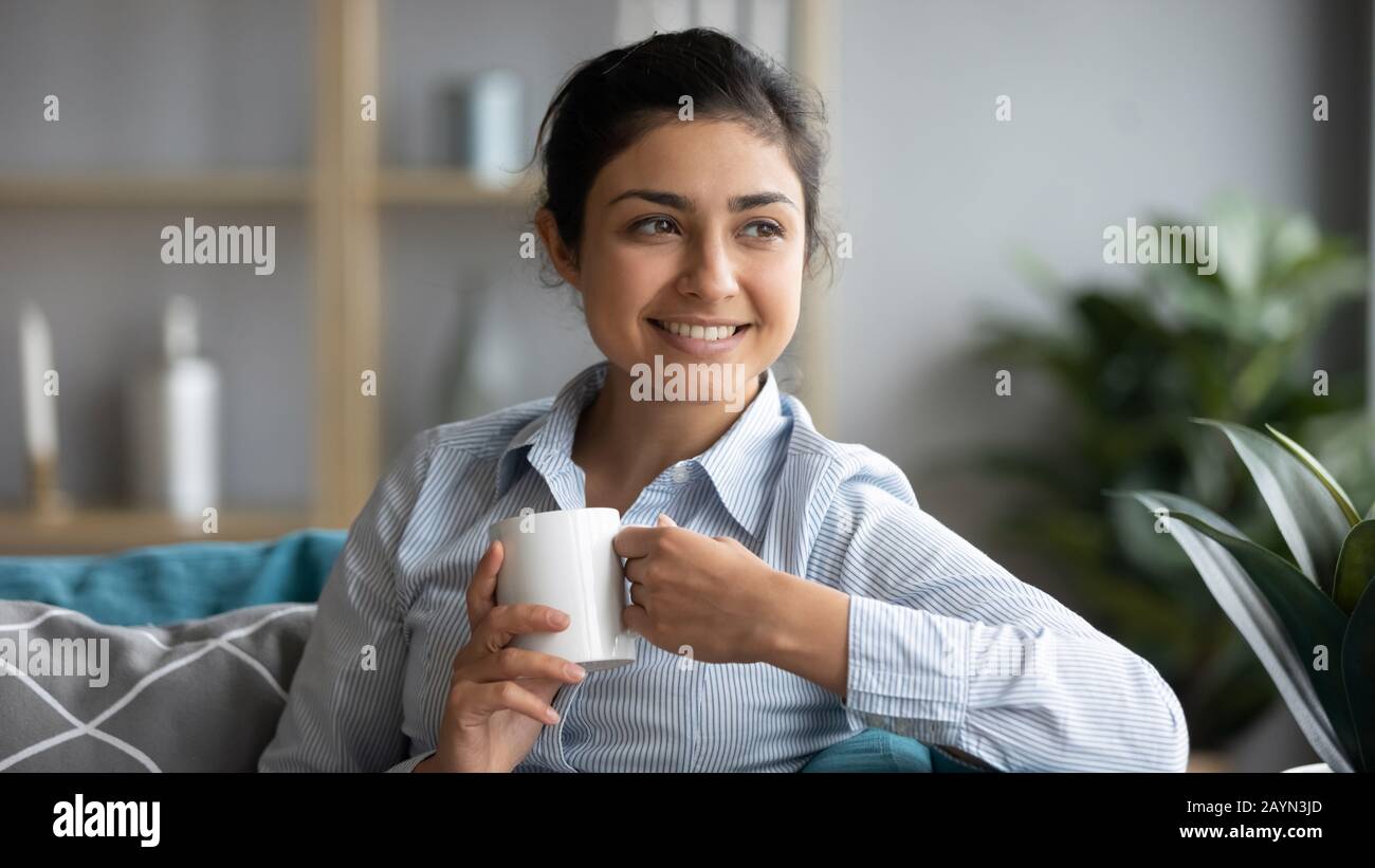 Happy indian woman drink warm tea relaxing at home Stock Photo - Alamy