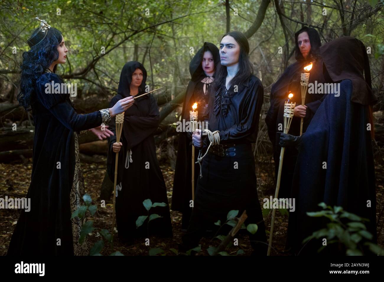 Female sorceress with assistants conduct magic ritual over a man Stock ...
