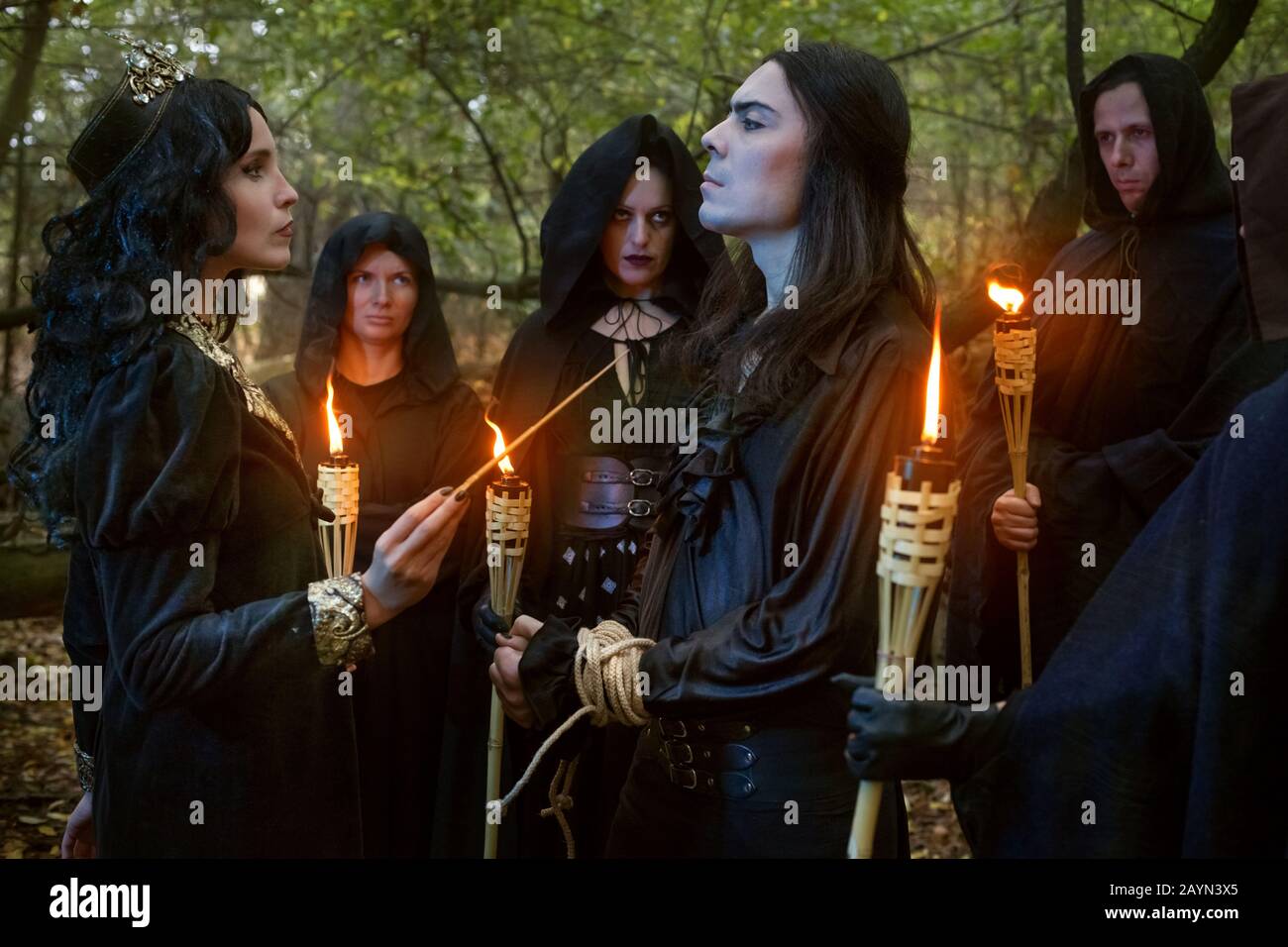 Evil sorceress conducts a magic ritual over a man in the forest Stock ...