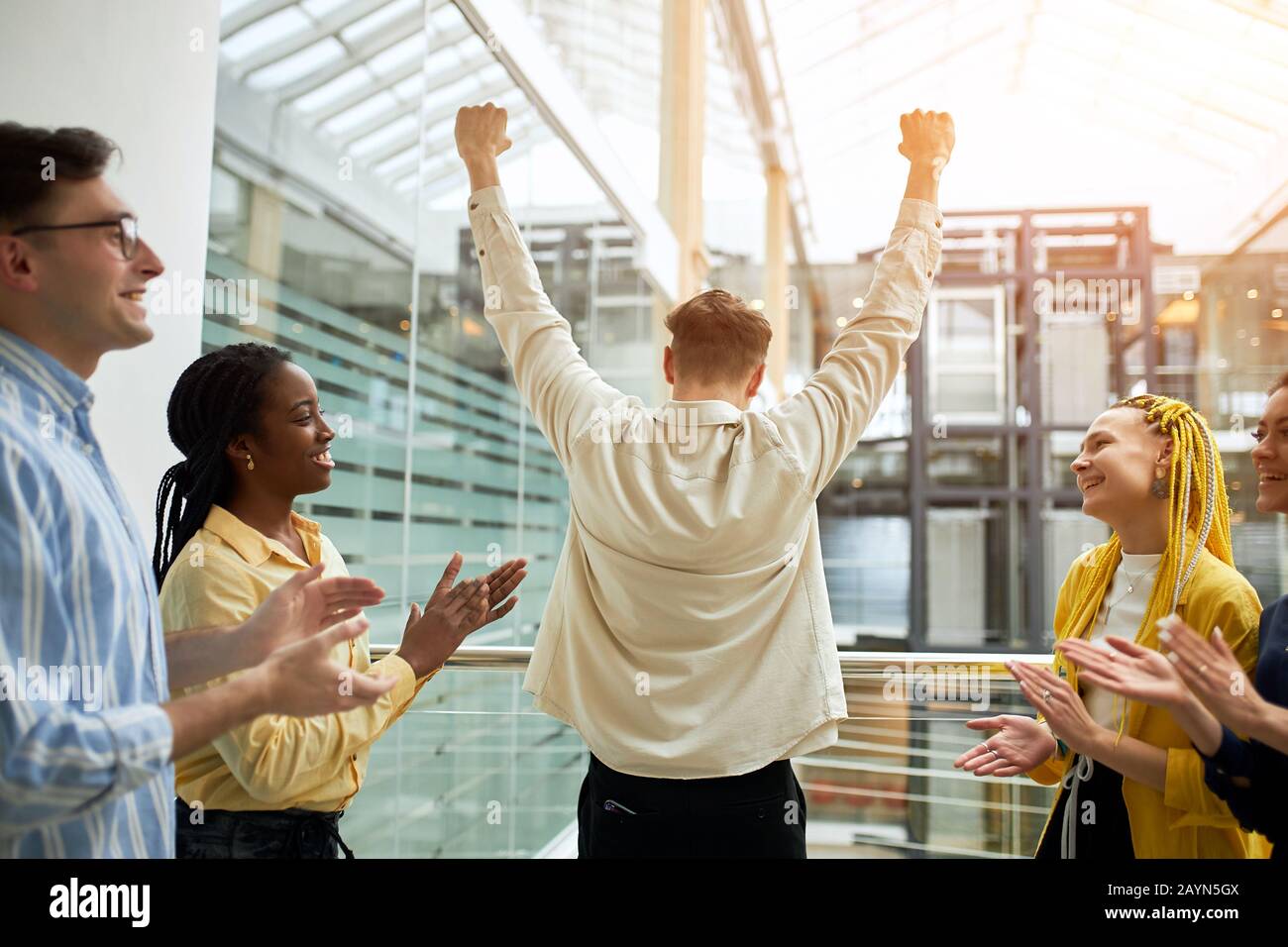 young leader is rejoicing at his success. his colleagues support him ...