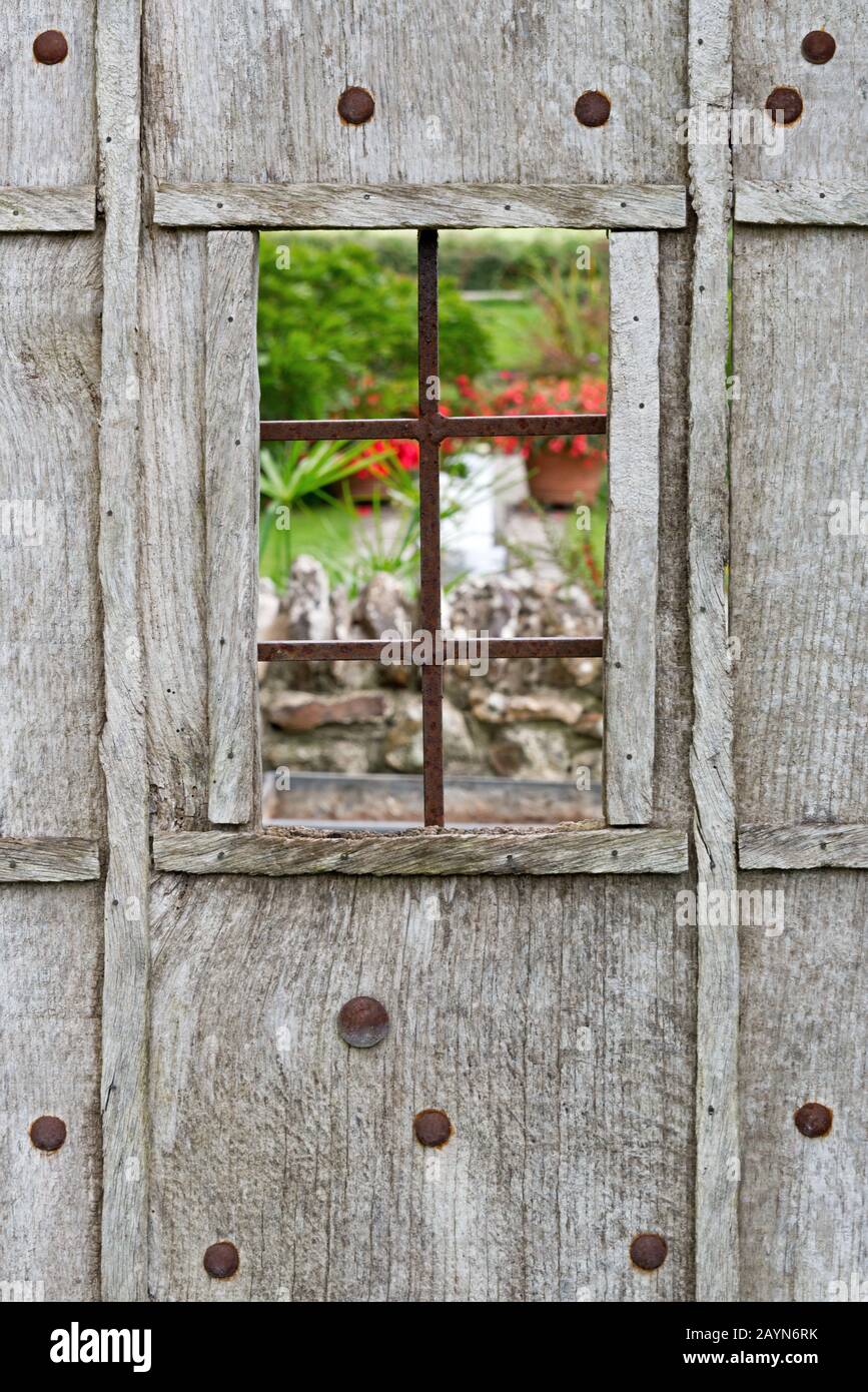 view through a door into the Millennium Garden at Burrow Farm Gardens ...