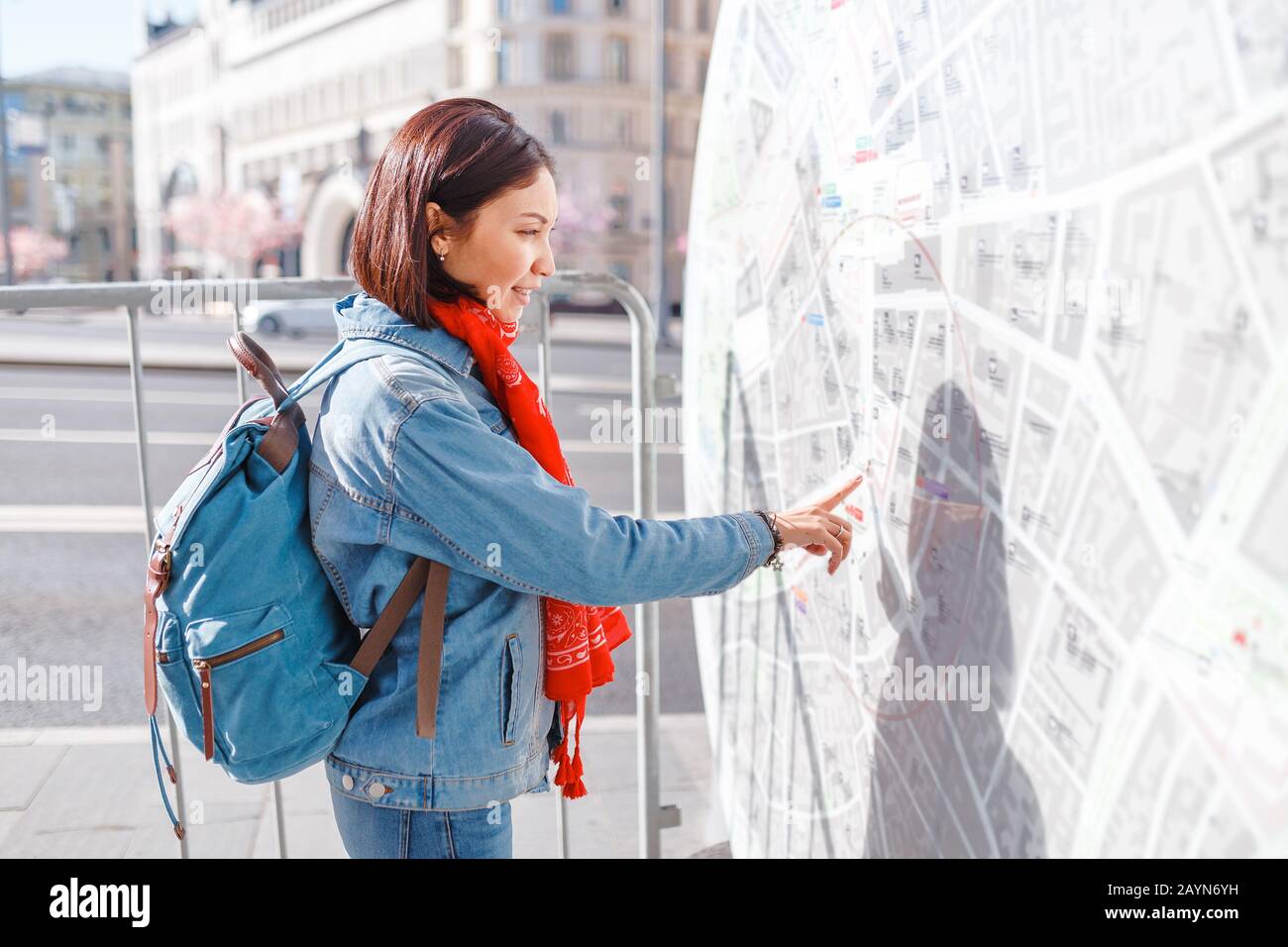 Female asian tourist looking at map visiting city and travel concept ...