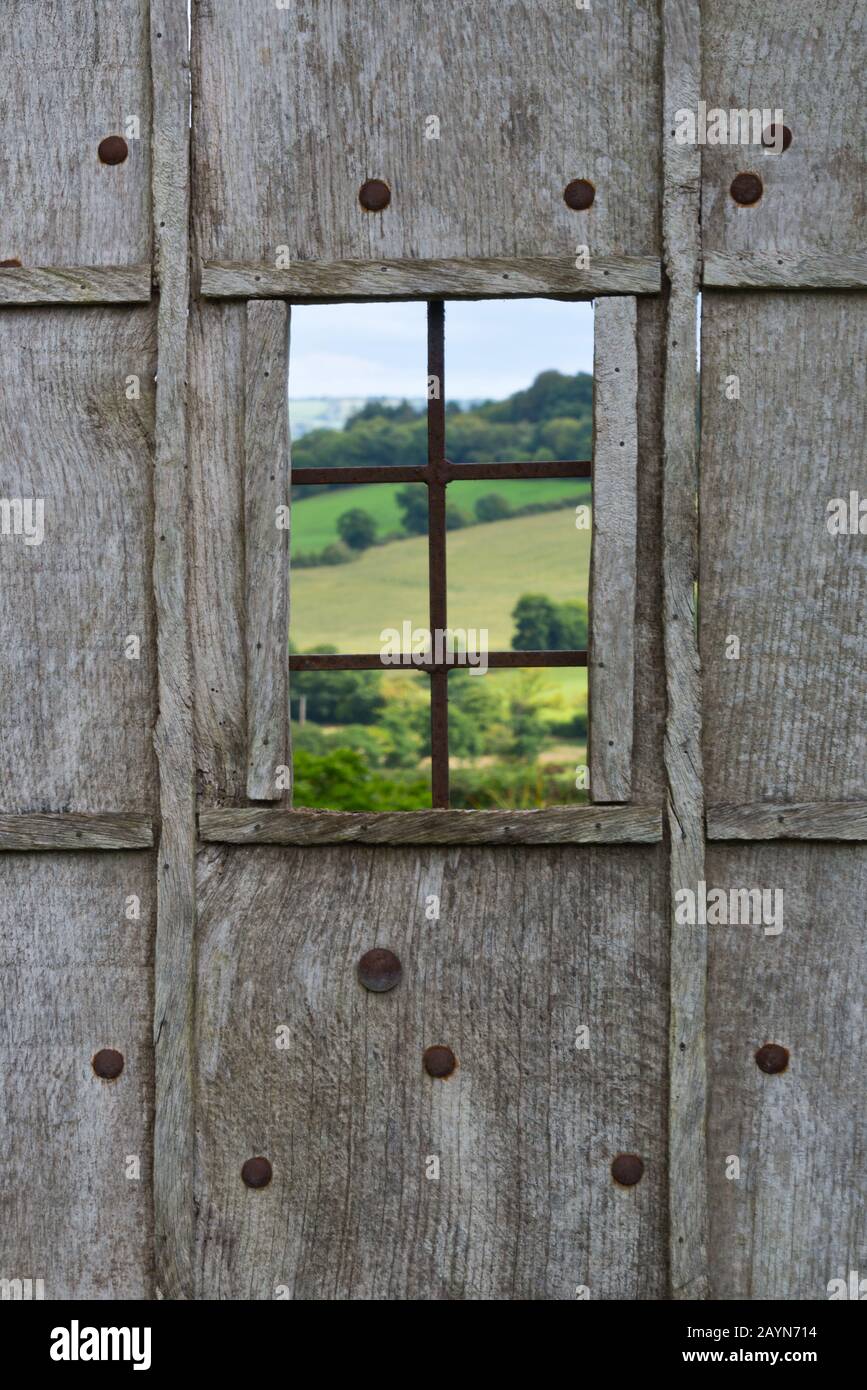 view through a door into the Millennium Garden at Burrow Farm Gardens ...