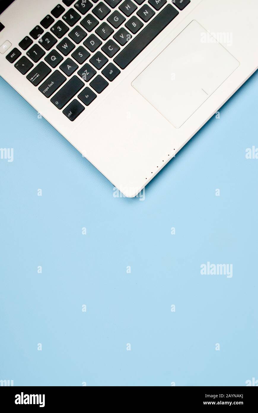 Black-white laptop keyboard on a blue background. The place for the ...