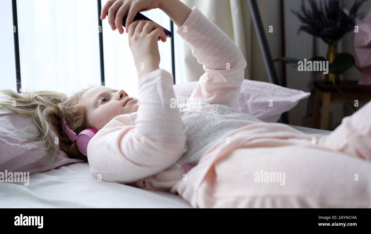 modern life of generation Z. teenage girl in pajamas and headphones in ...