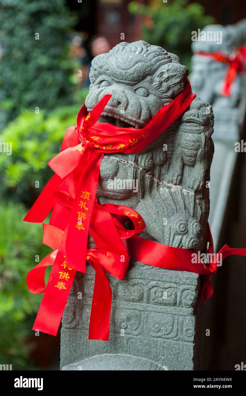 Red prayer ribbons in the courtyard of the Jade Buddha Temple, a ...