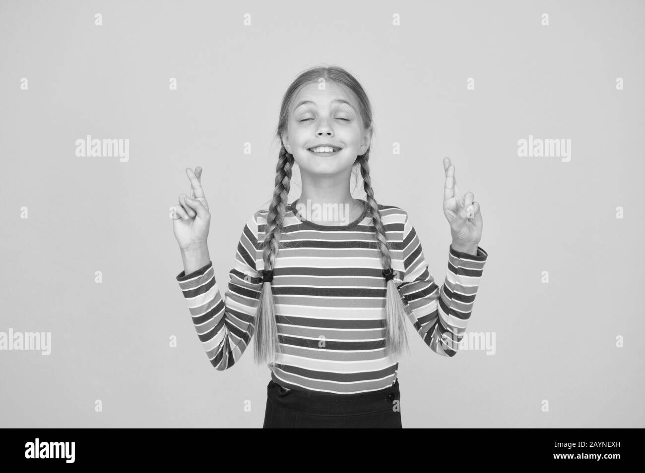 I dont want to jinx it. Cute child make wish yellow background. Little ...