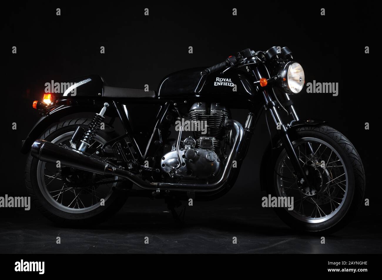 a classic black motorcycle in front of a black studiobackdrop Stock ...