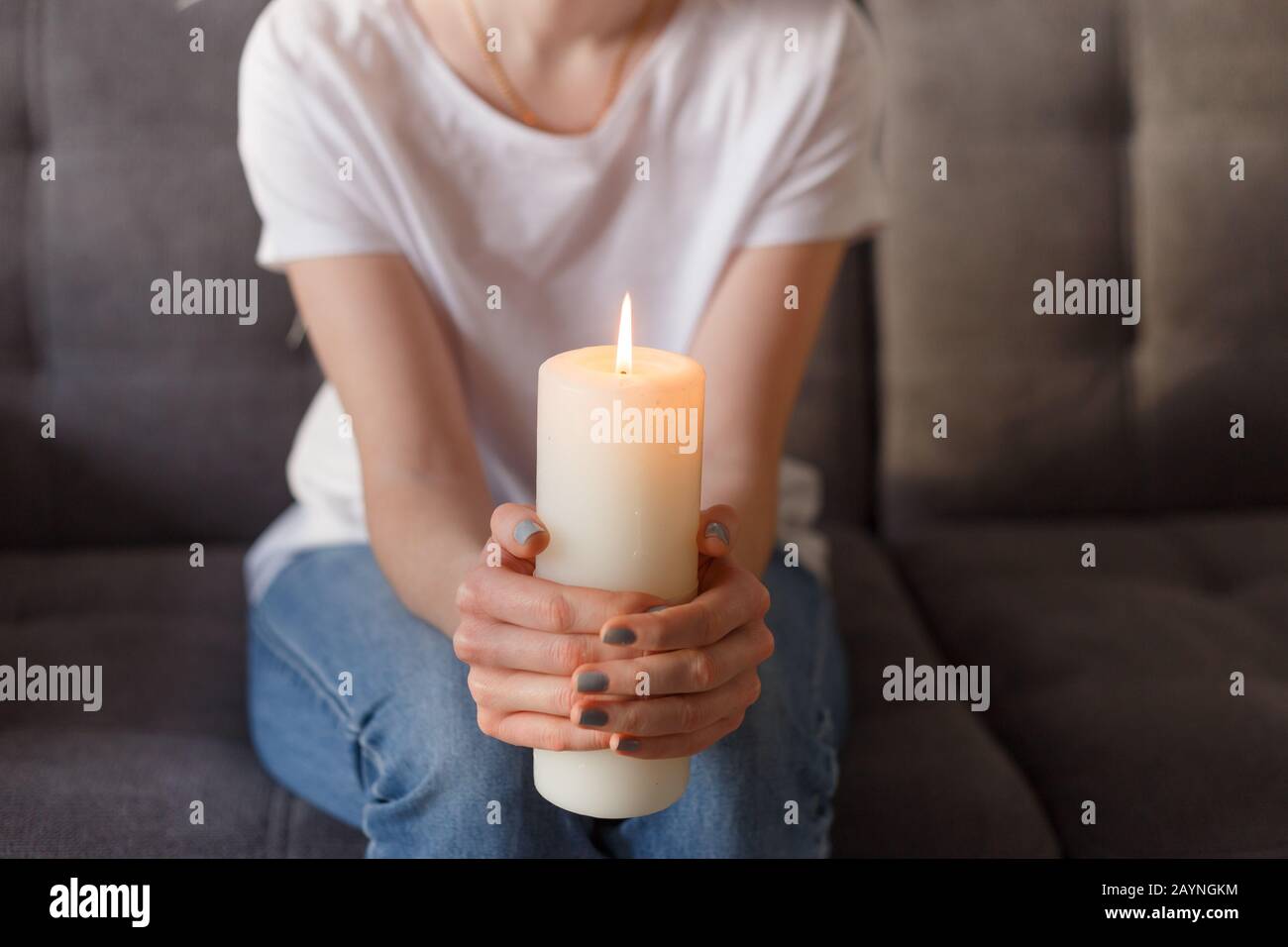 woman holding burning candle in her hands Stock Photo - Alamy