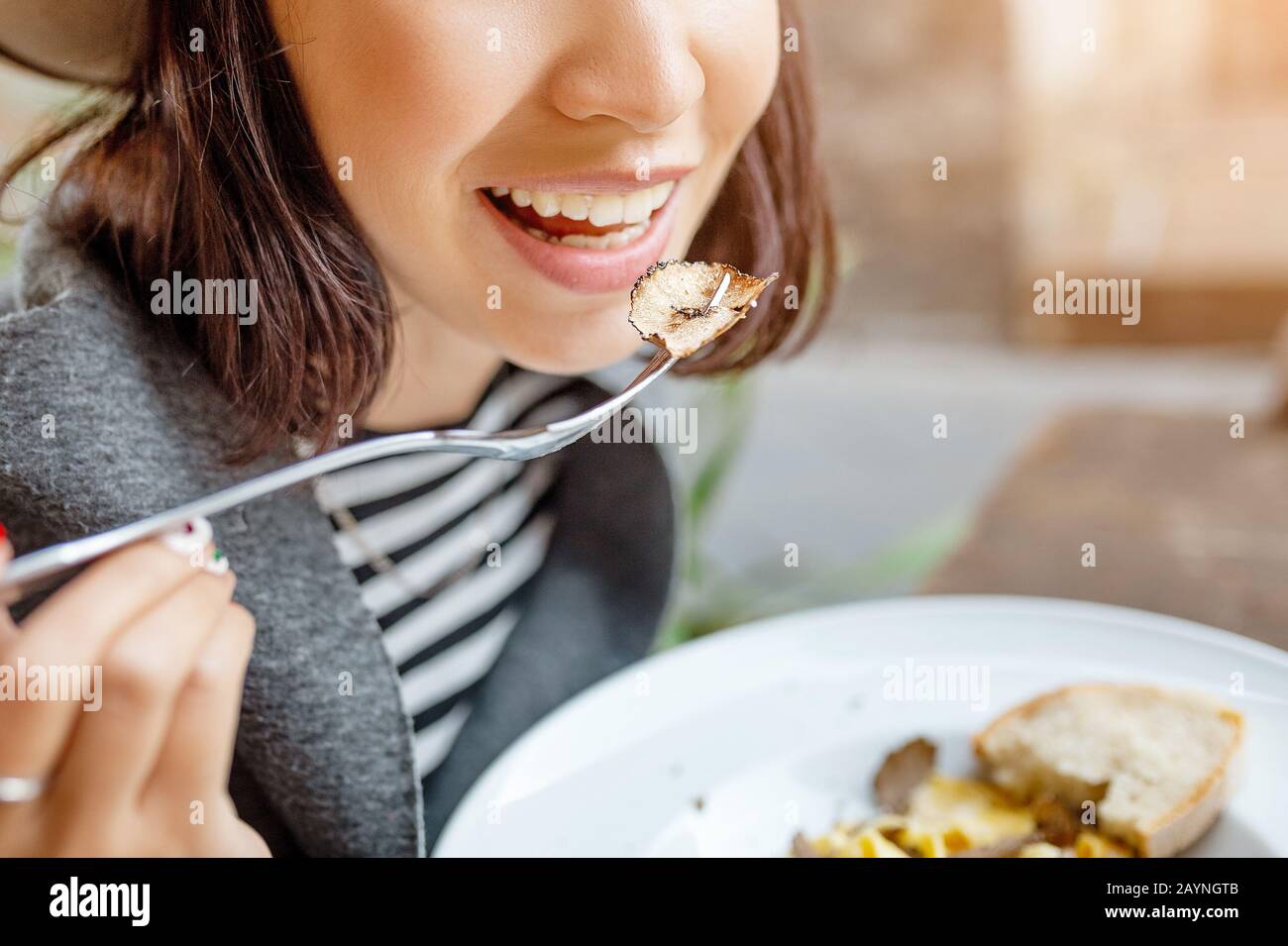 Happy asian woman eating pasta with truffle in outdoor italian ...