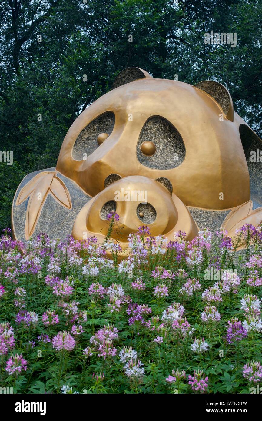 A Panda statue with flowers in the garden of the Chengdu Panda Breeding ...