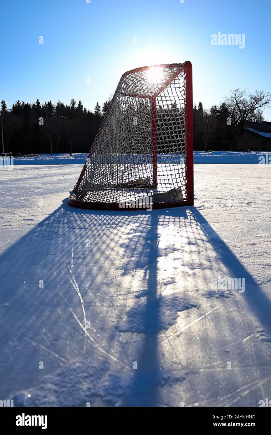 Sun silhouetting a empty hockey net on a frozen pond Stock Photo - Alamy Sun silhouetting a empty hockey net on a frozen pond Stock Photo - Alamy