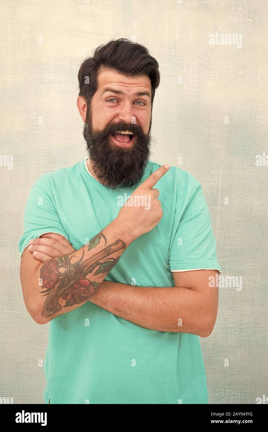 Look there. Bearded man pointing up isolated on white. Happy hipster ...